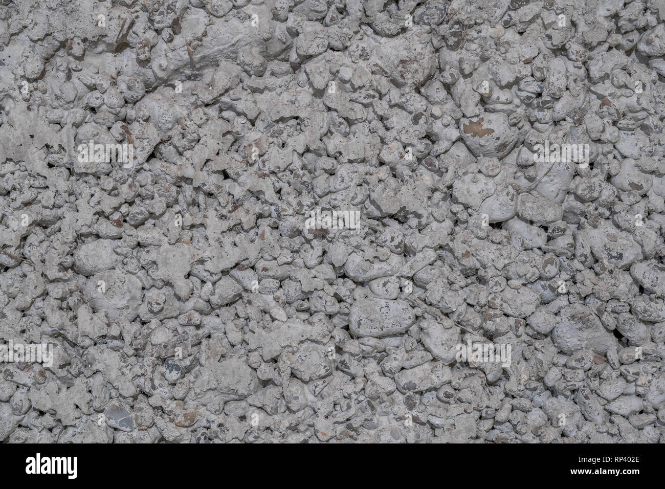 The texture of the old wall on a building made of cement mixed with ...
