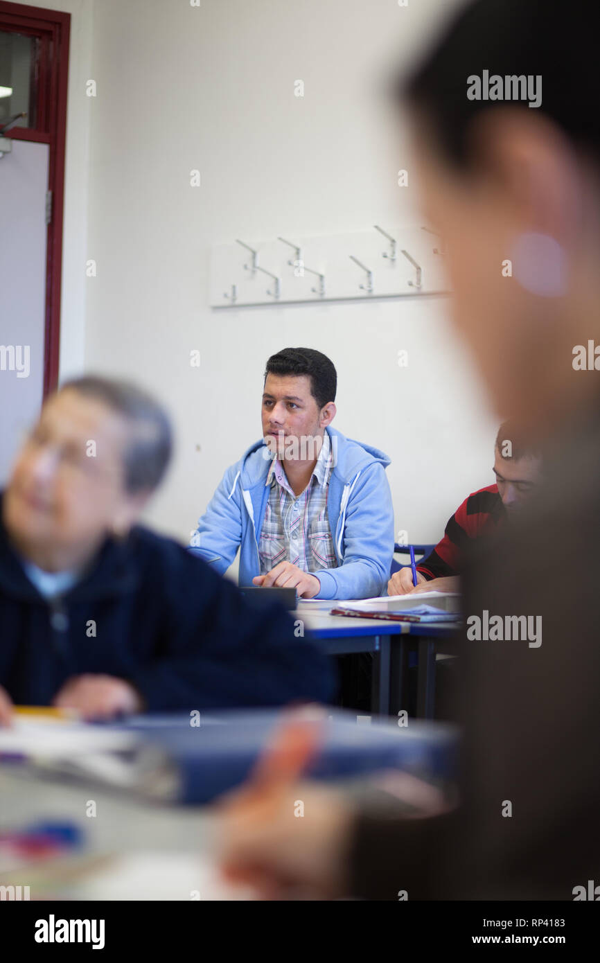 men in a classroom studying ESOL, English for speakers of other ...