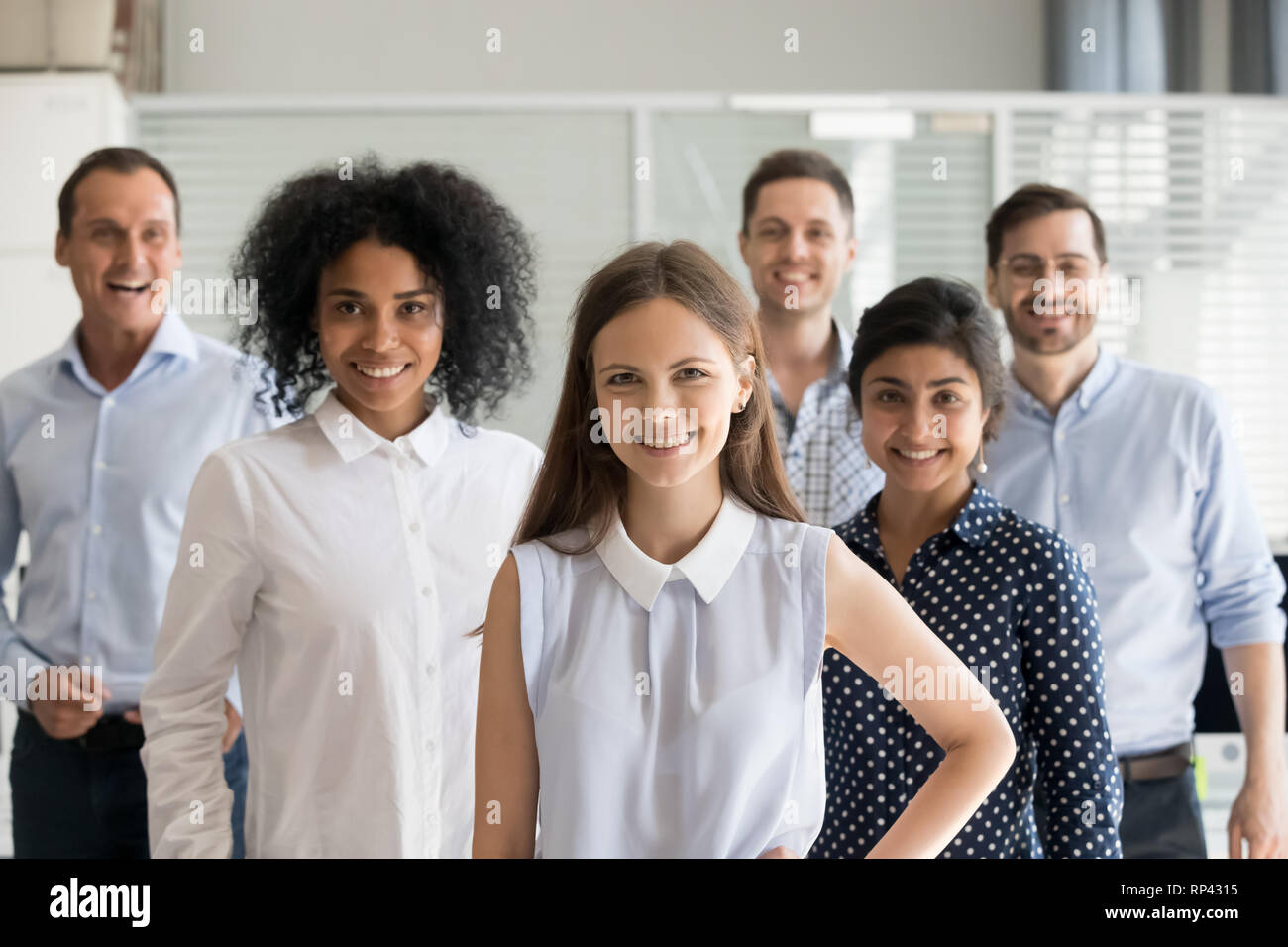 Diverse team headed by successful attractive leader woman standing ...