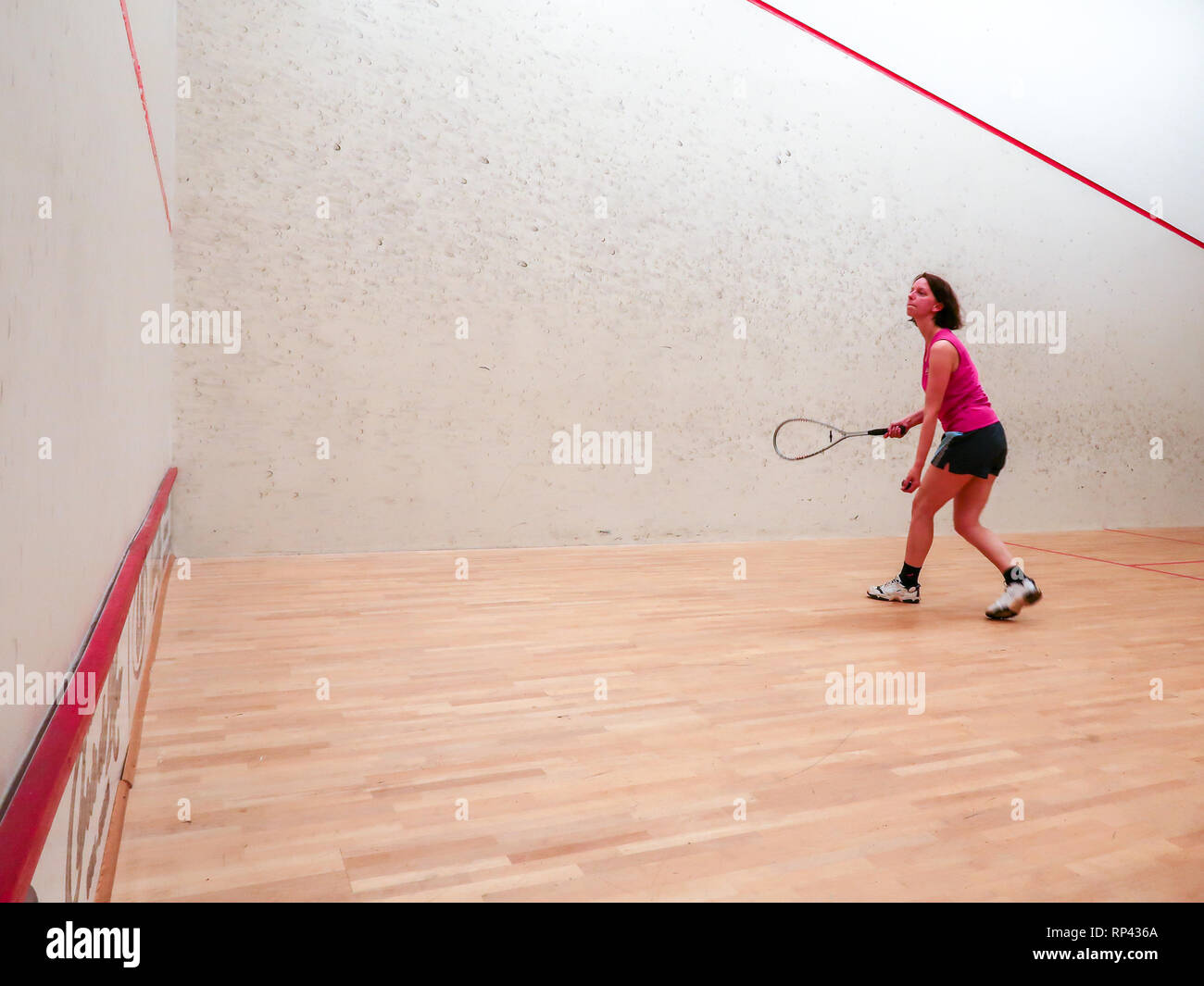 Woman is playing squash Stock Photo - Alamy