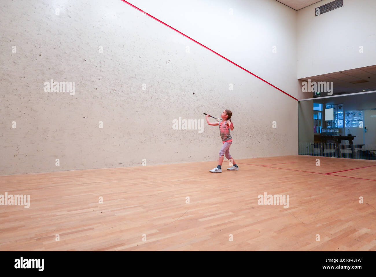 Woman is playing squash Stock Photo - Alamy