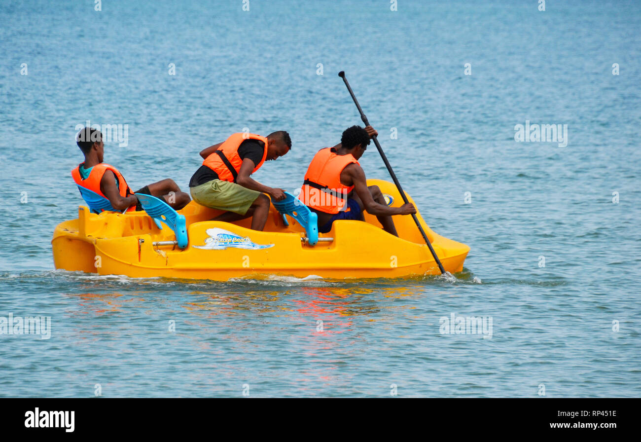 Men boating in the sea just off the coast at Knoll Beach, Studland Bay ...