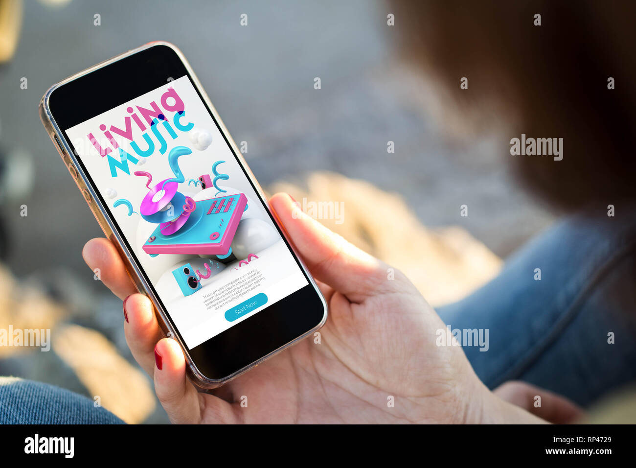 close-up view of young woman browsing music website on her mobile phone ...