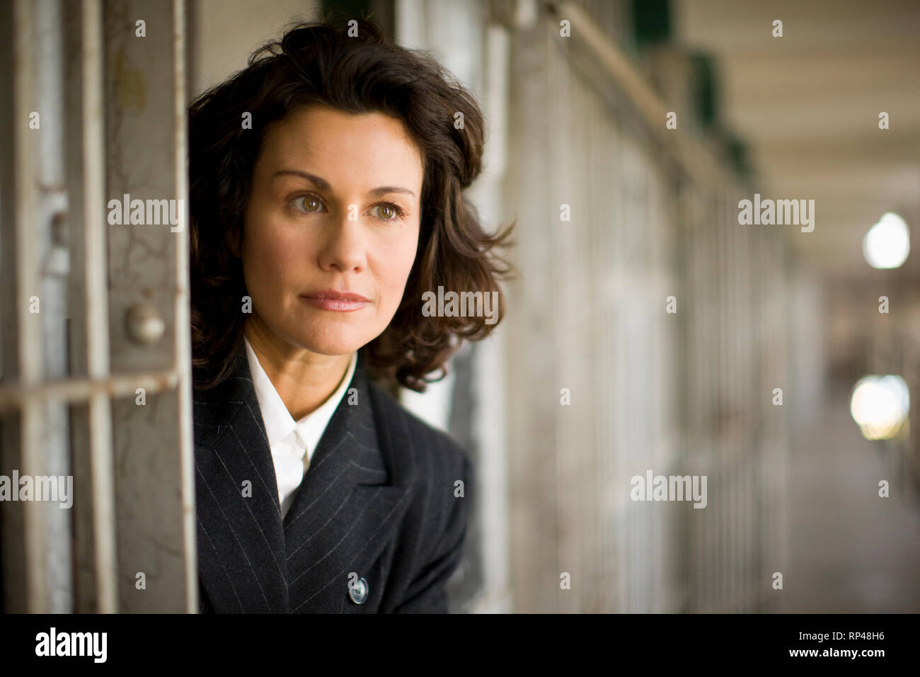 Mid-adult business woman inside a cell of a derelict building Stock ...