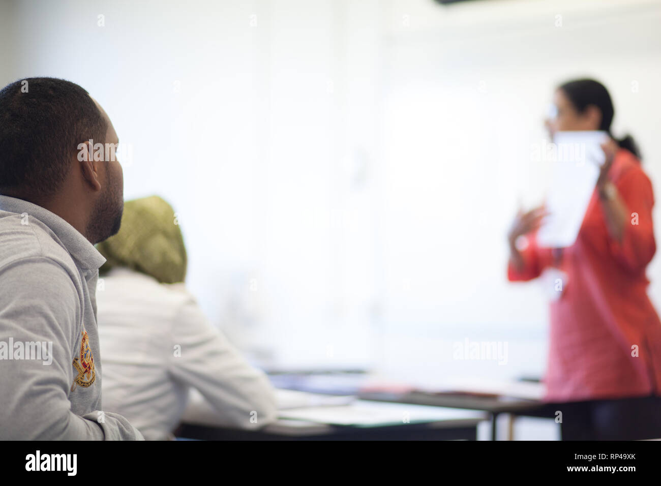 teacher in a classroom teaching ESOL, English for speakers of other ...