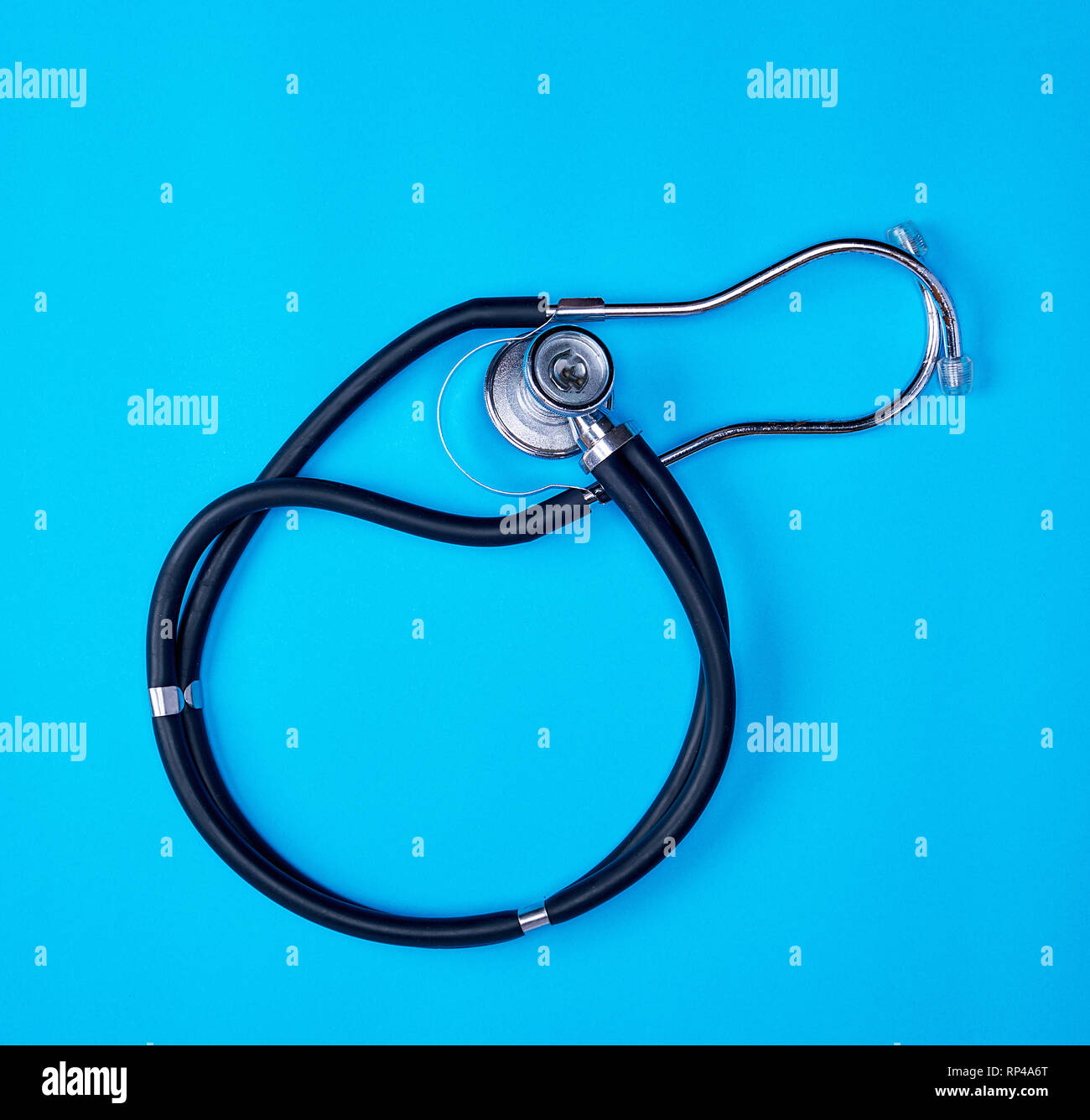 black medical phonendoscope on blue background Stock Photo - Alamy
