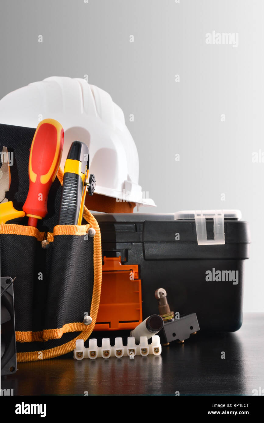 Composition with tools and electrical equipment on black table ...