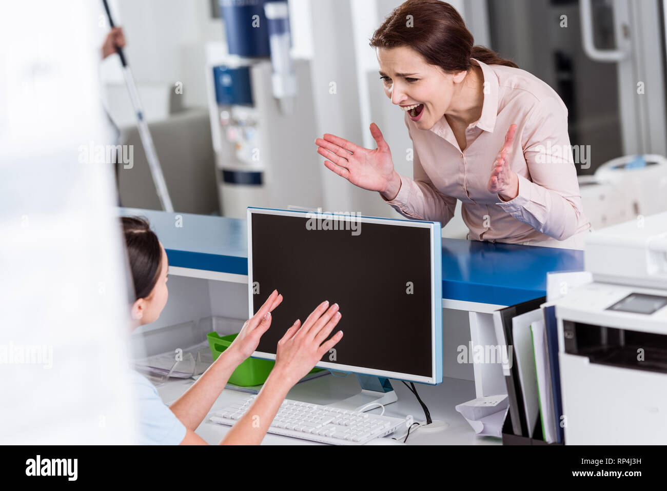 Aggressive patient screaming at nurse in clinic Stock Photo - Alamy