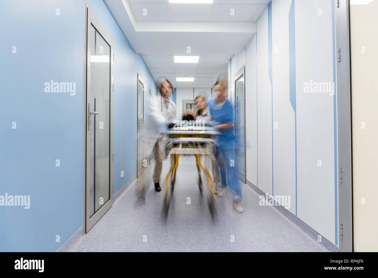 Group of doctors transportating patient on gurney Stock Photo - Alamy