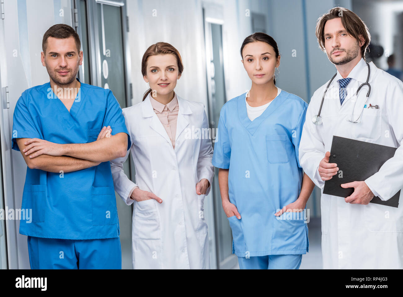Doctors and nurses in blue uniform looking at camera Stock Photo - Alamy