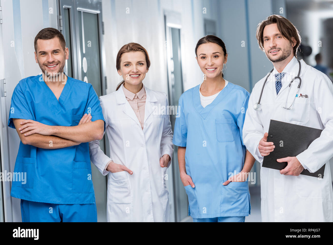 Laughing doctors and nurses looking at camera Stock Photo - Alamy