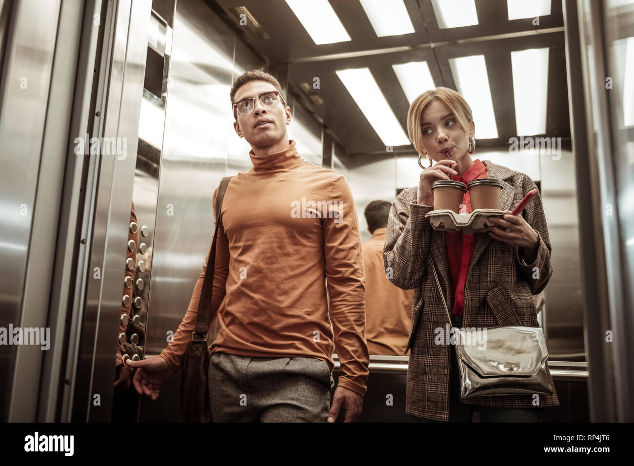 Couple of businessmen taking the elevator while going to work Stock ...