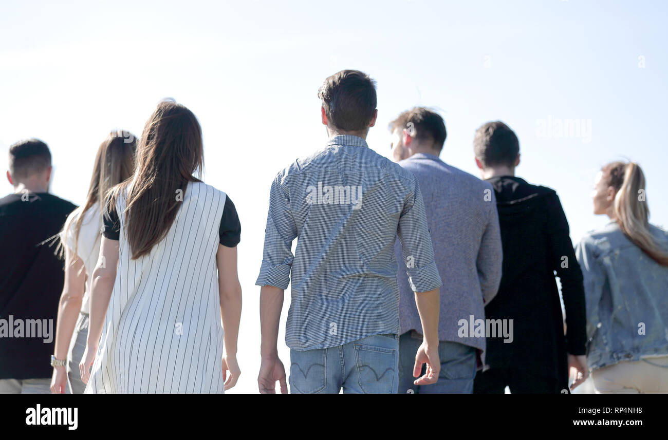 rear view . group of friends showing standing together Stock Photo - Alamy