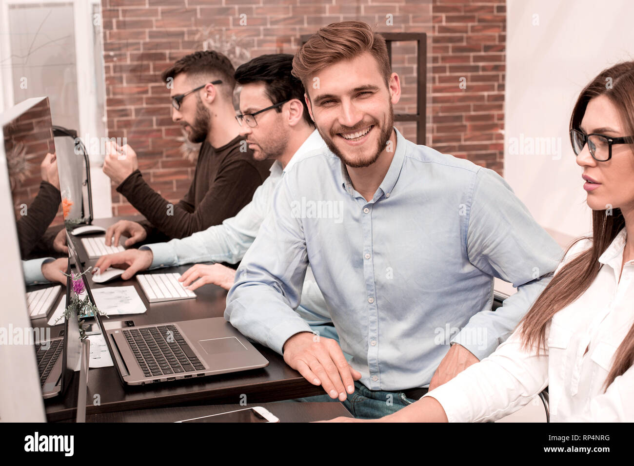 smiling employee of the business center in the workplace Stock Photo ...