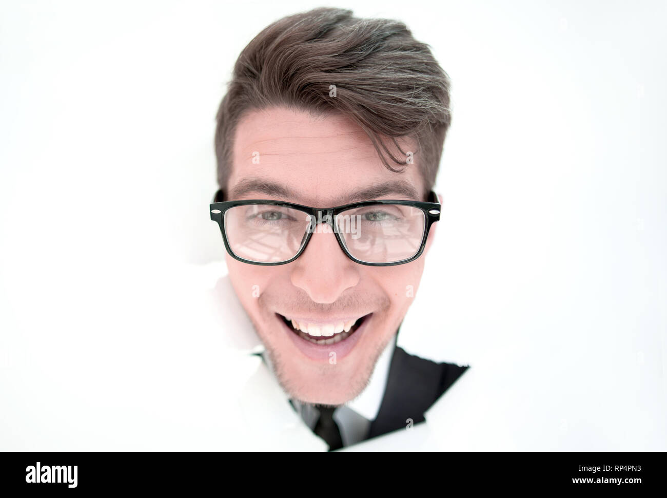 young businessman breaking through a white paper wall Stock Photo - Alamy