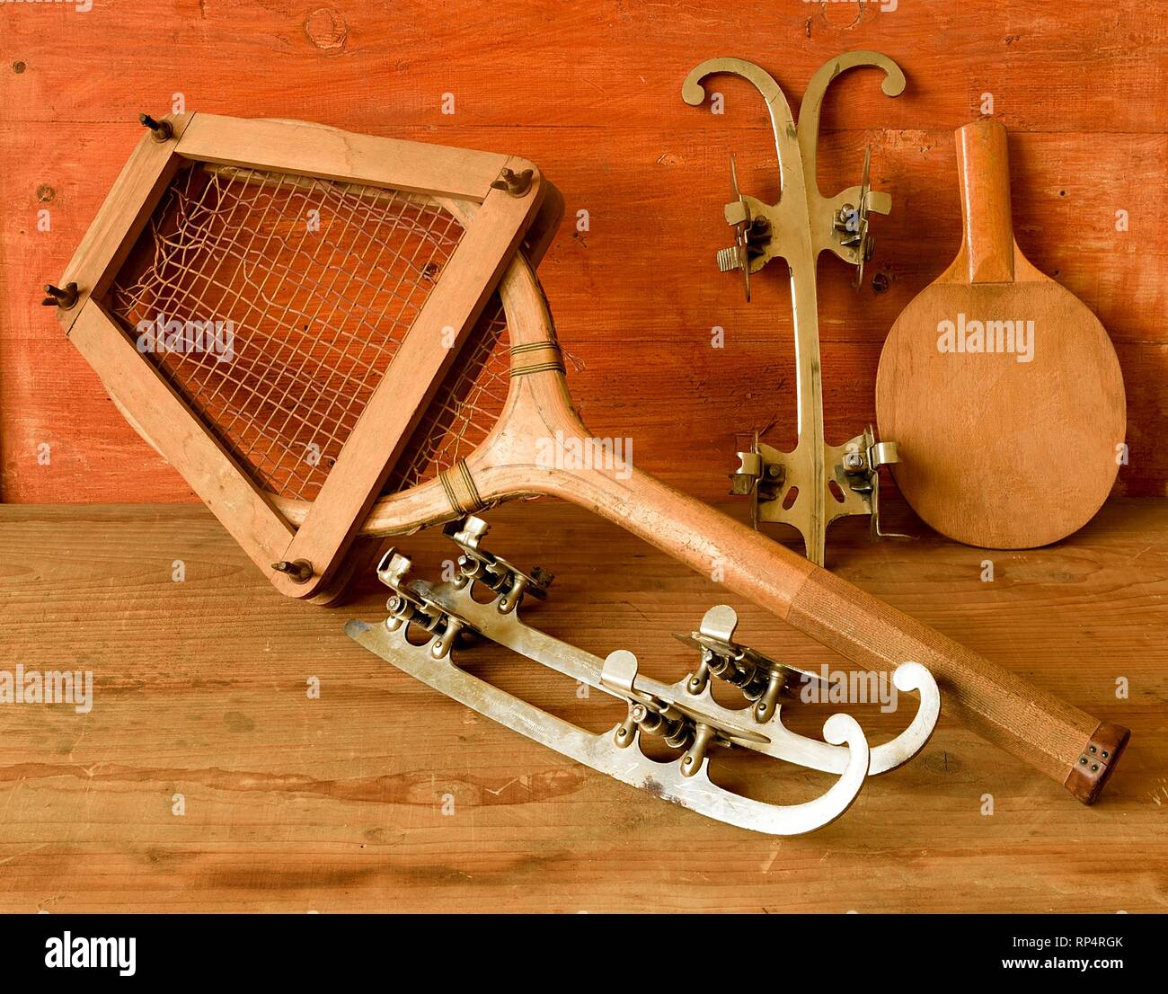 Vintage ice skates and tennis racket on wooden background. Retro ice ...