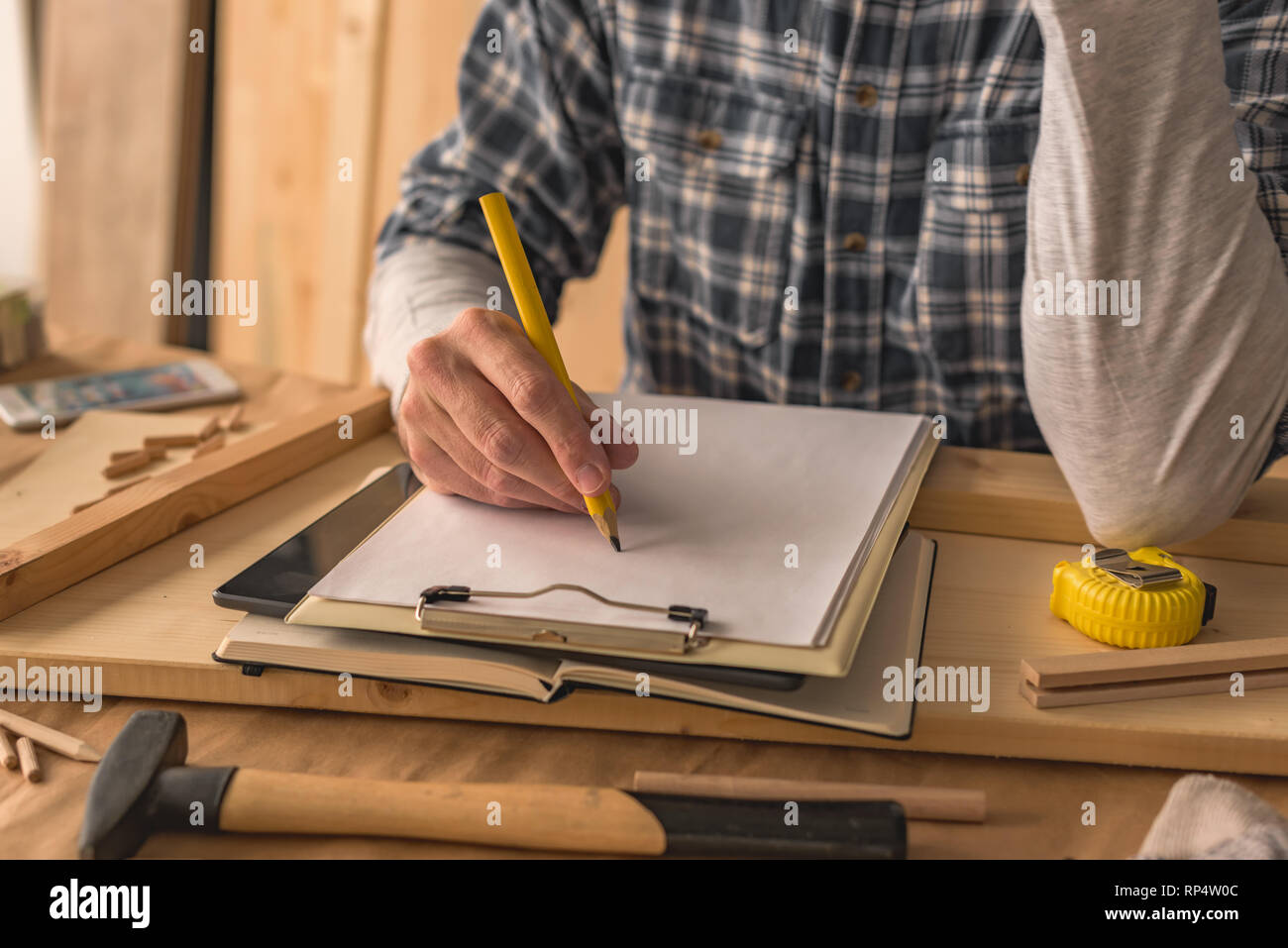 Carpenter writing clipboard notepad paper project notes and to do list ...