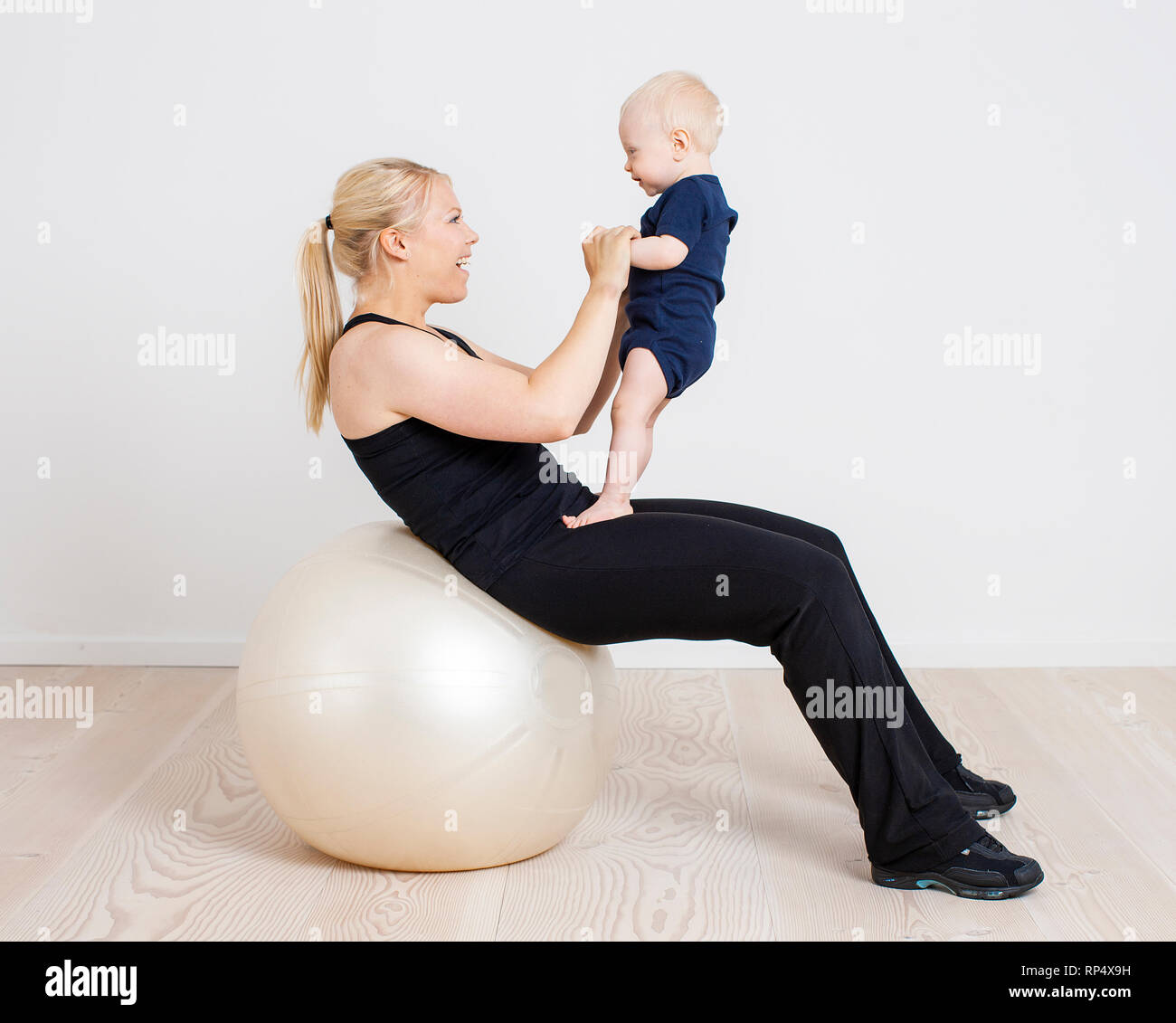 Mother and baby exercise Stock Photo - Alamy