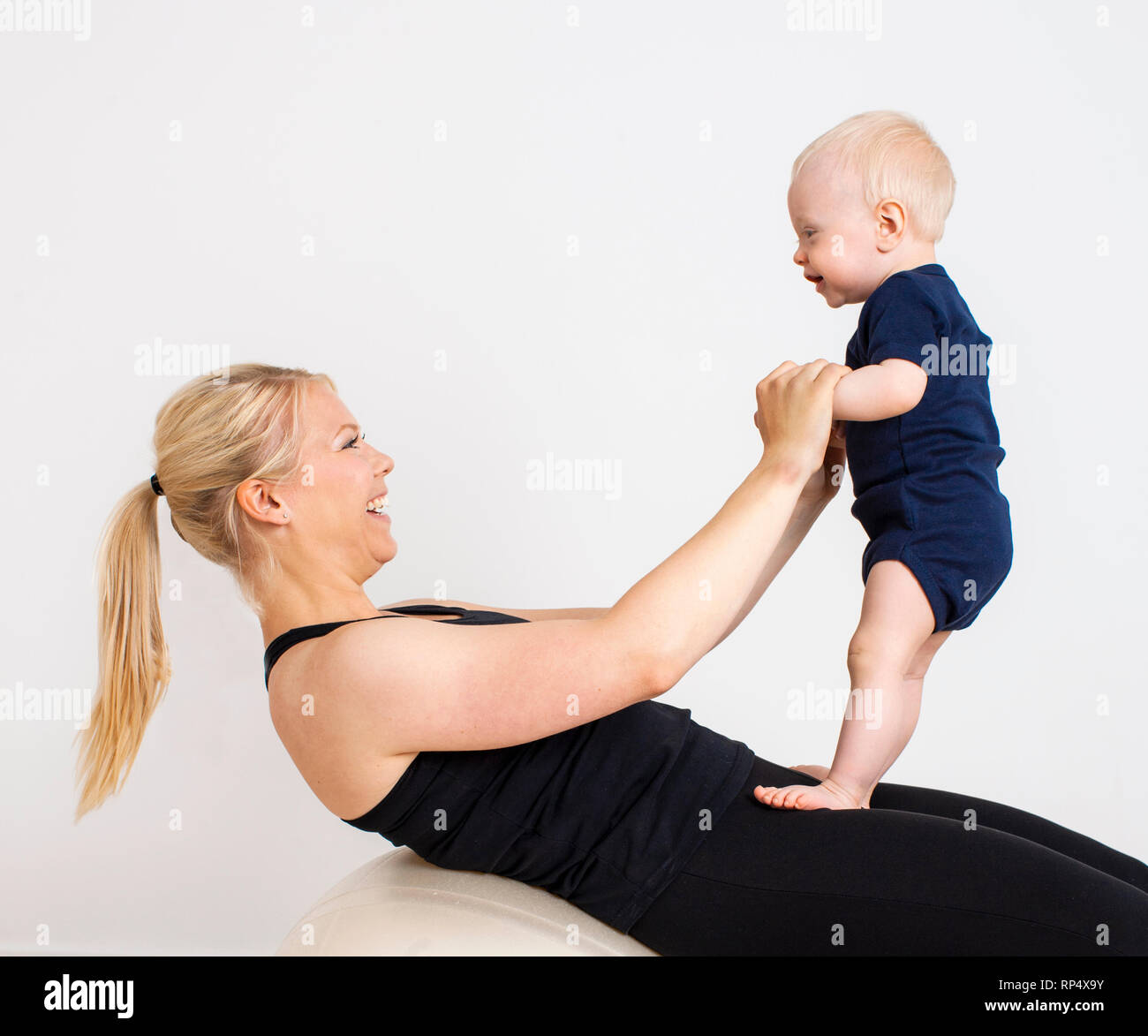 Mother and baby exercise Stock Photo - Alamy