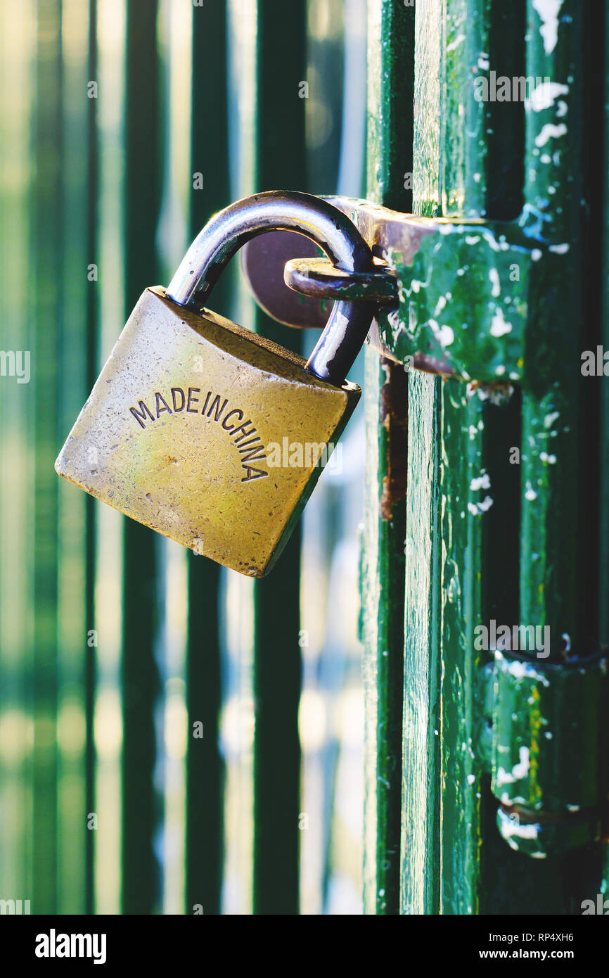 Worn padlock with Made in China imprint locking the metal gate Stock ...