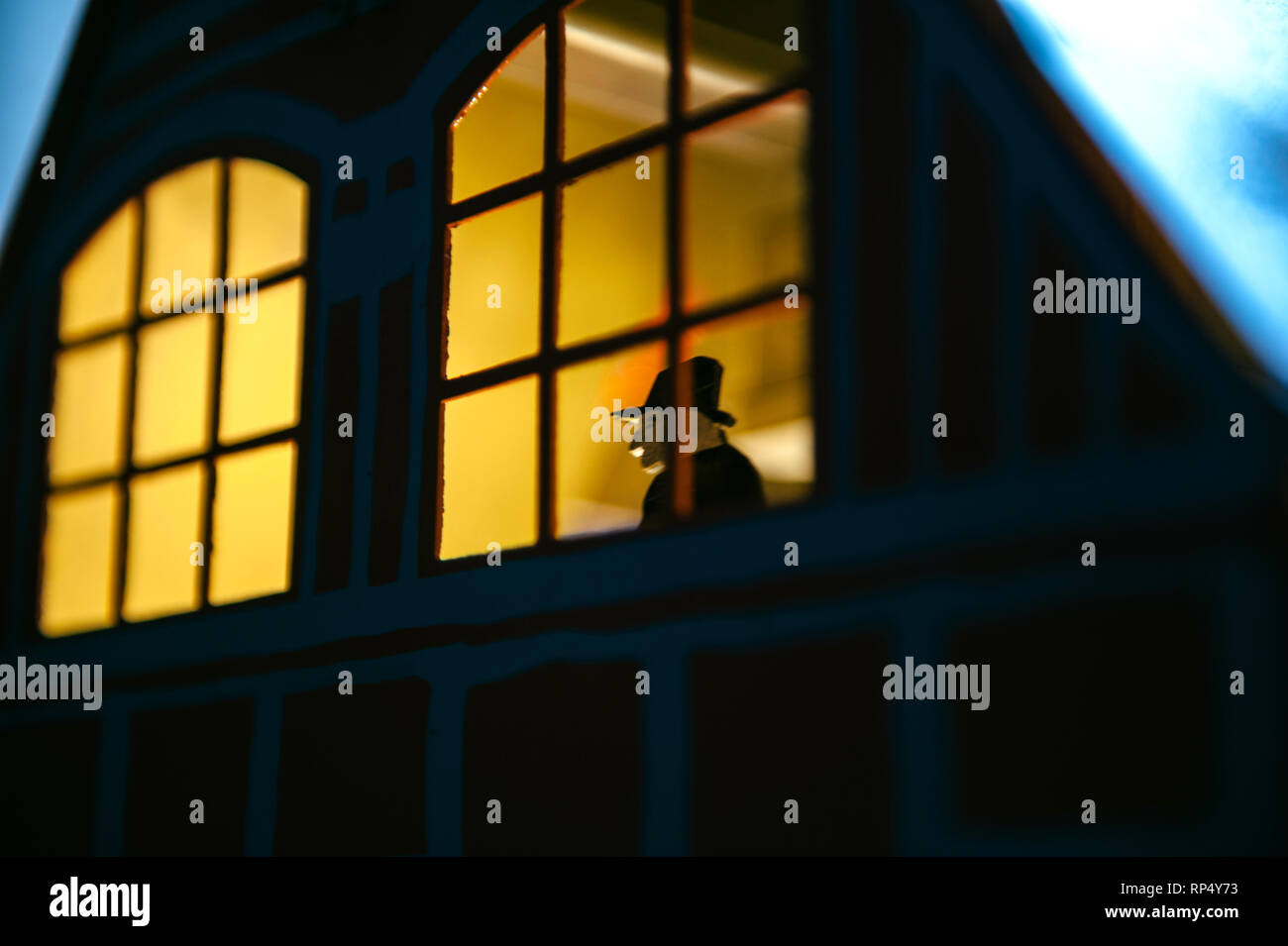 Toy house with windows illuminated from the inside during Christmas ...