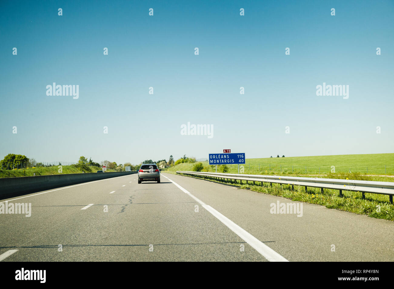 Rear view of car driving fast to Montargis and Orleans on French ...