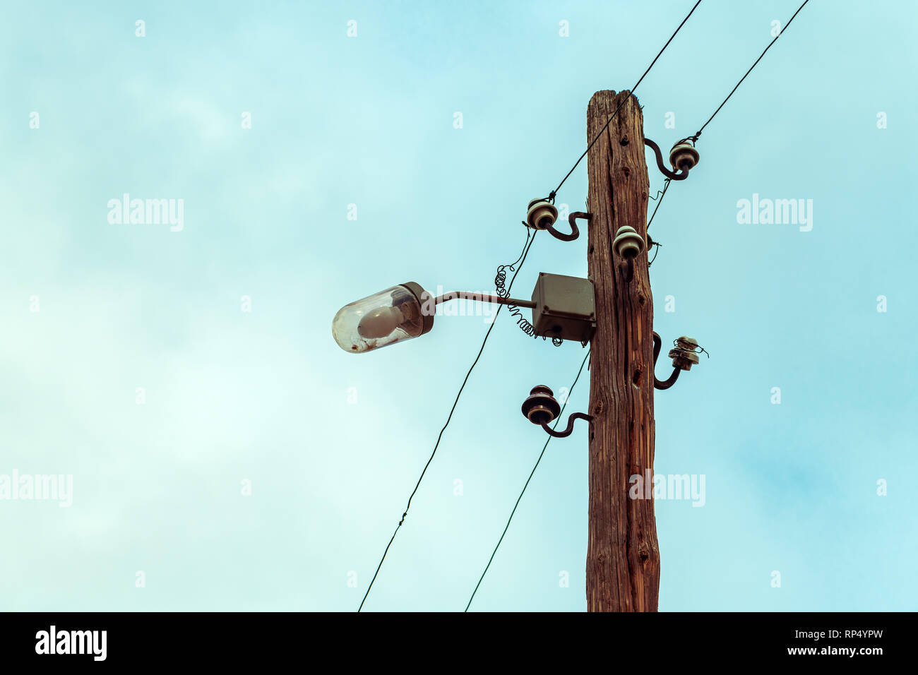 Wooden electricity pylon with wires and light lamp Stock Photo - Alamy