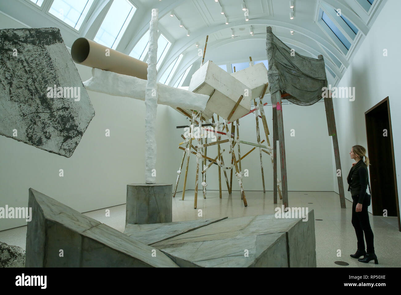 A woman is seen viewing Phyllida Barlow's installation at the Royal ...