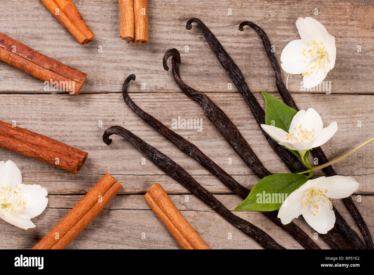 Vanilla sticks and cinnamon with flower and leaf on a old wooden ...