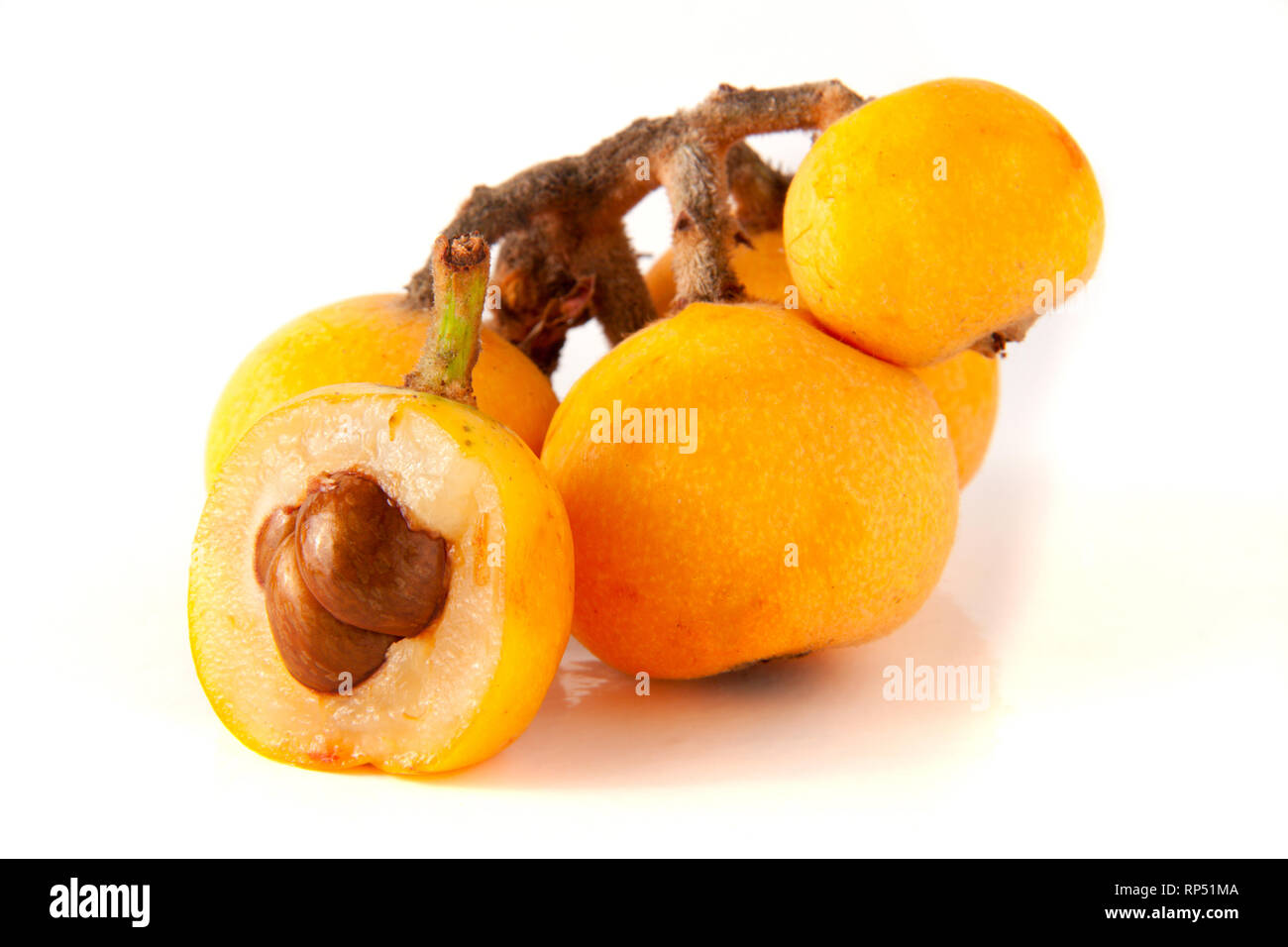 Ripe loquat or Eriobotrya japonica with leaf isolated on white ...