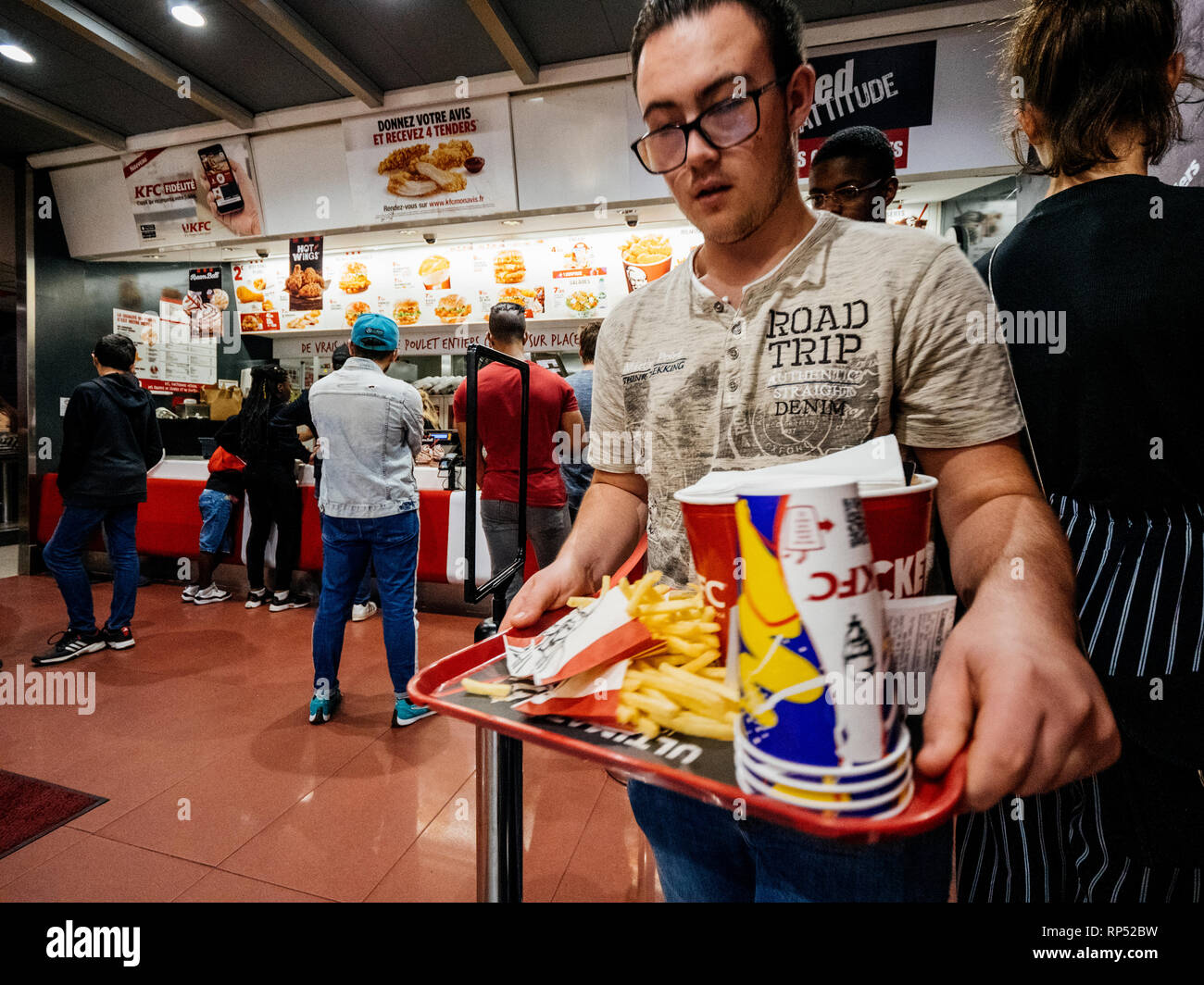 PARIS, FRANCE - OCT 13, 2018: Young man with lots of fast-food inside ...