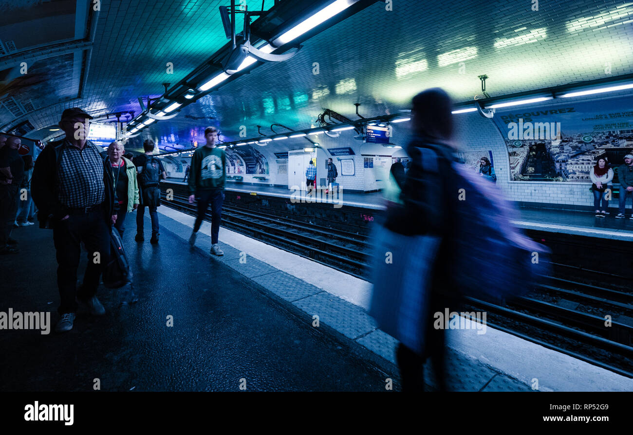 PARIS, FRANCE - OCT 13, 2018: Blue color cast over commuters large ...