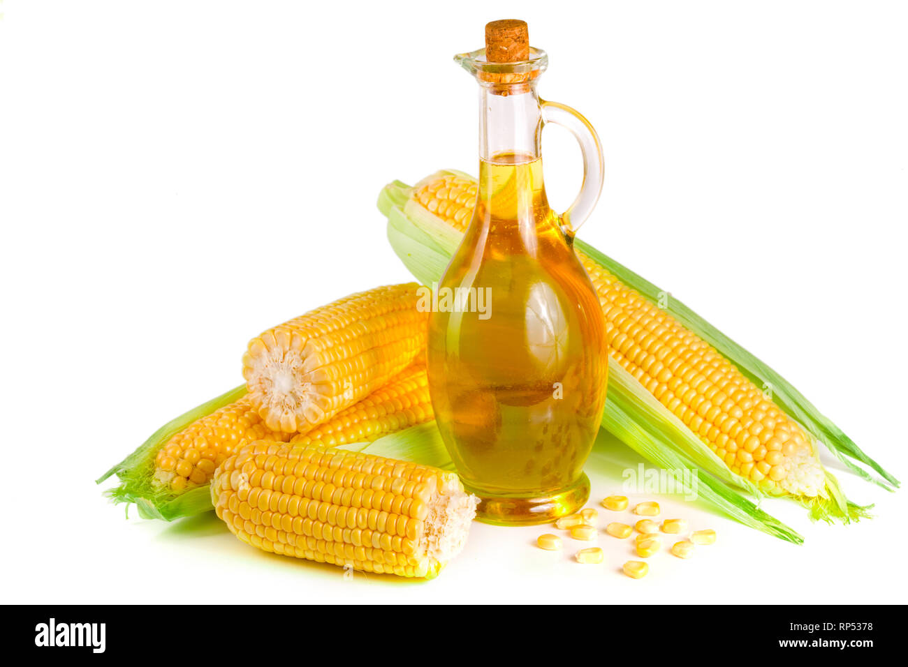 Corn oil in decanter, fresh corn cobs and grains isolated on white ...