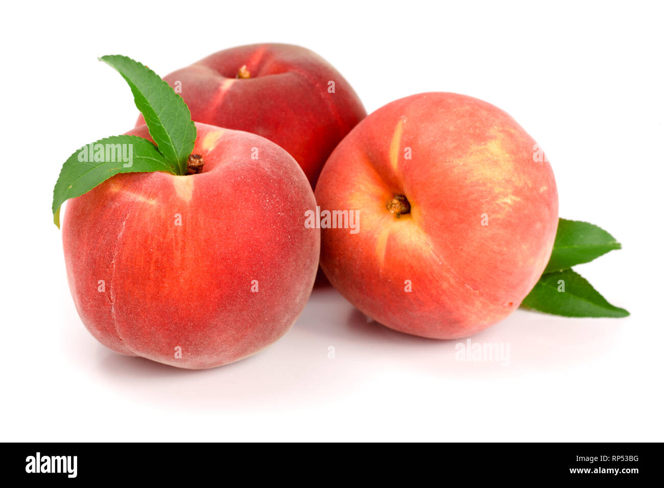 Three peaches with green leaf isolated on white background Stock Photo ...