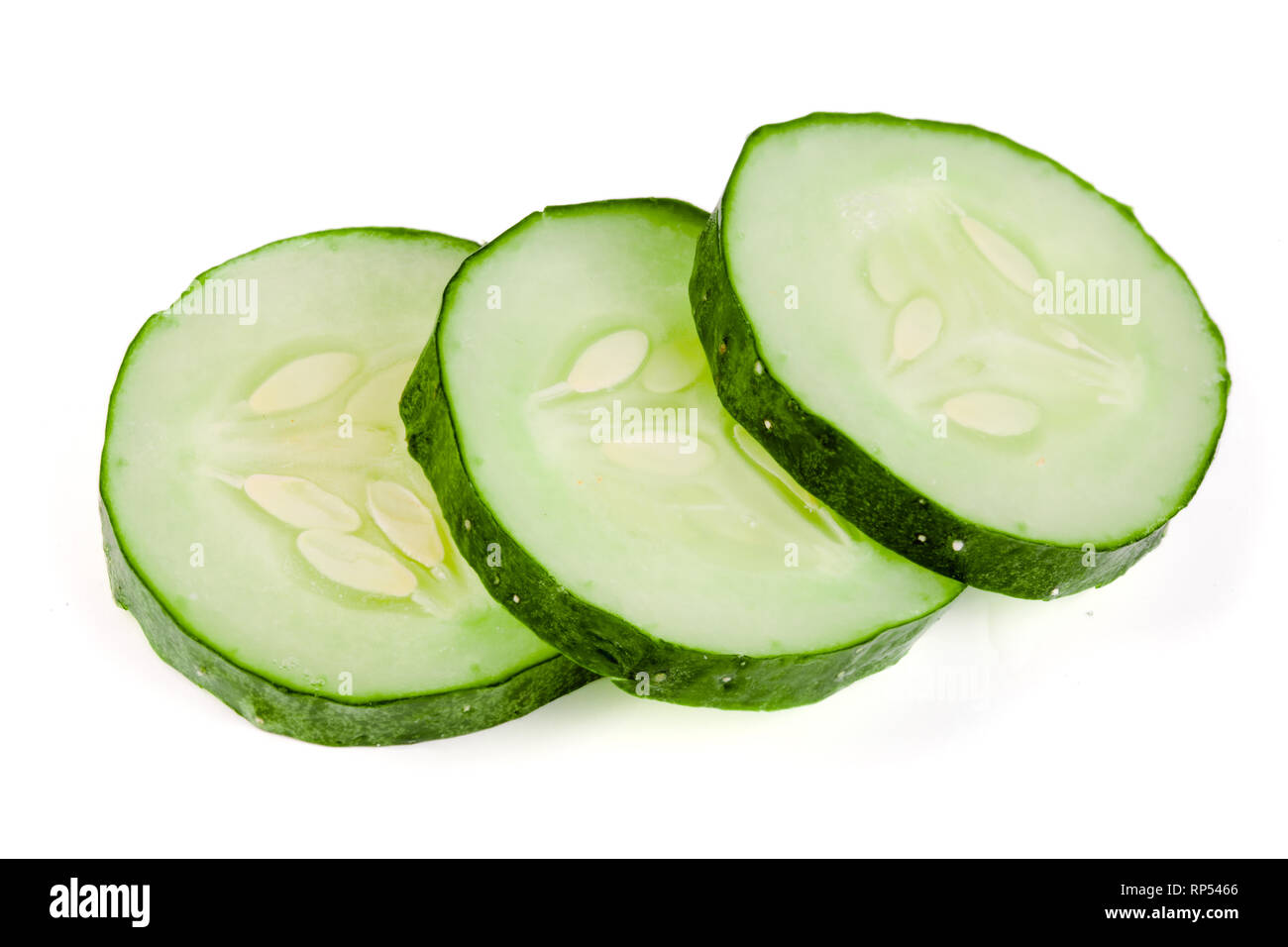 Three slices of cucumber isolated on white background Stock Photo - Alamy