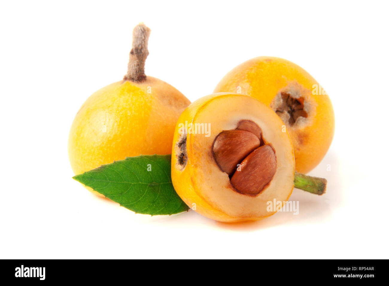 Ripe loquat or Eriobotrya japonica with leaf isolated on white ...
