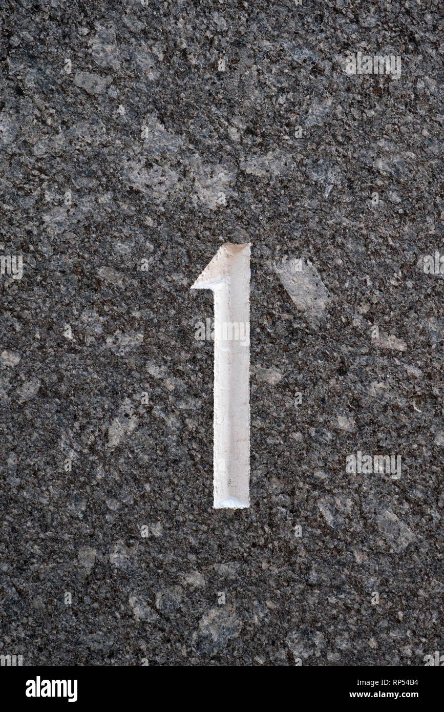 A White Number One Door Number Carved Into A Grey Stone Wall Stock ...
