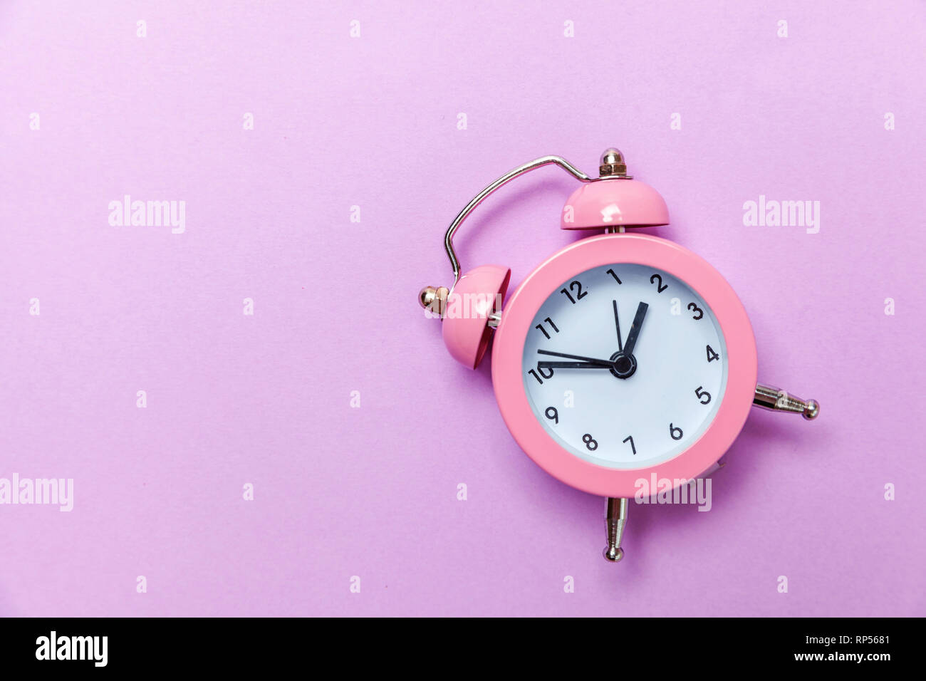 Ringing twin bell vintage classic alarm clock Isolated on purple violet ...
