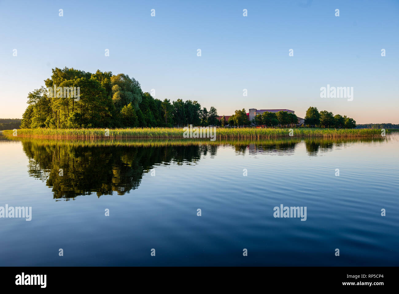 calm weather sunset on country lake with calm water and silent simmetry ...