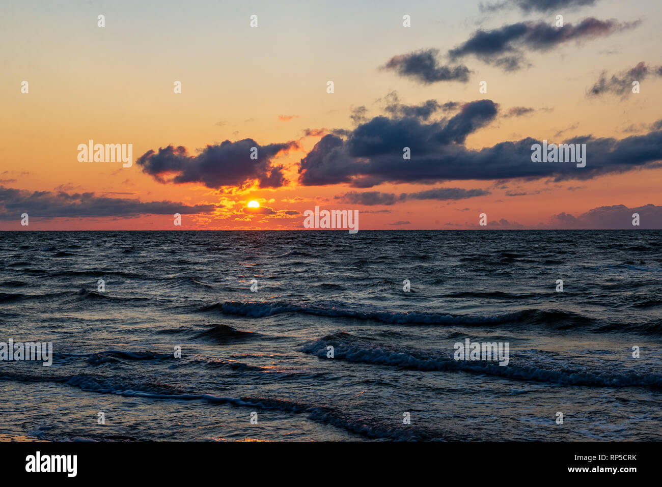 colorful sunset on the sea beach in summer with clean sky and calm ...