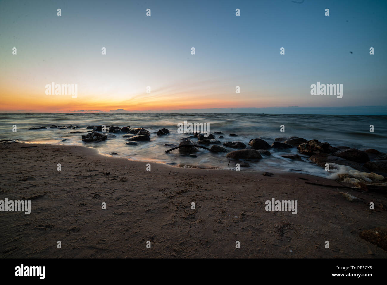 colorful sunset on the sea beach in summer with clean sky and calm ...