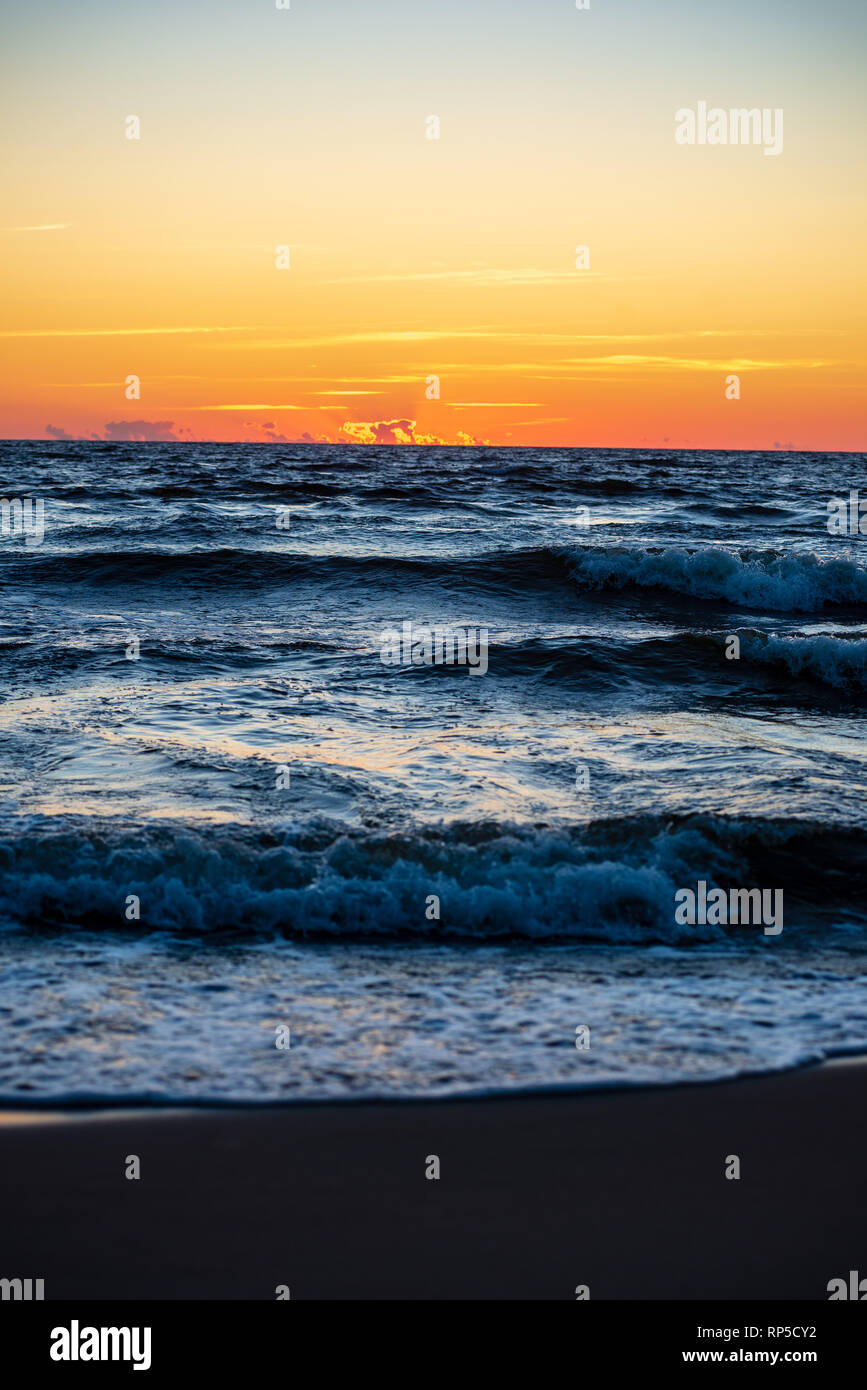 colorful sunset on the sea beach in summer with clean sky and calm ...