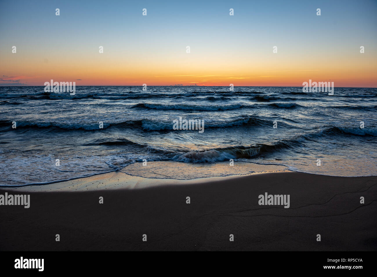 colorful sunset on the sea beach in summer with clean sky and calm ...