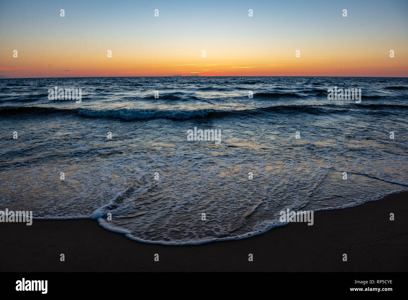 colorful sunset on the sea beach in summer with clean sky and calm ...