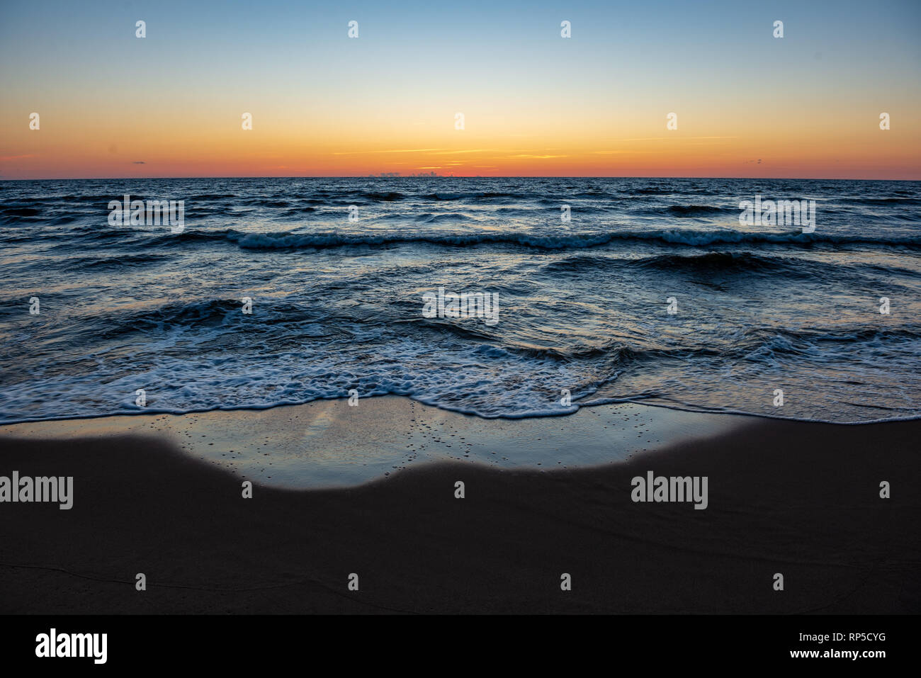 colorful sunset on the sea beach in summer with clean sky and calm ...