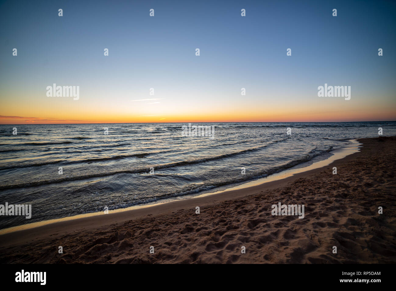 colorful sunset on the sea beach in summer with clean sky and calm ...