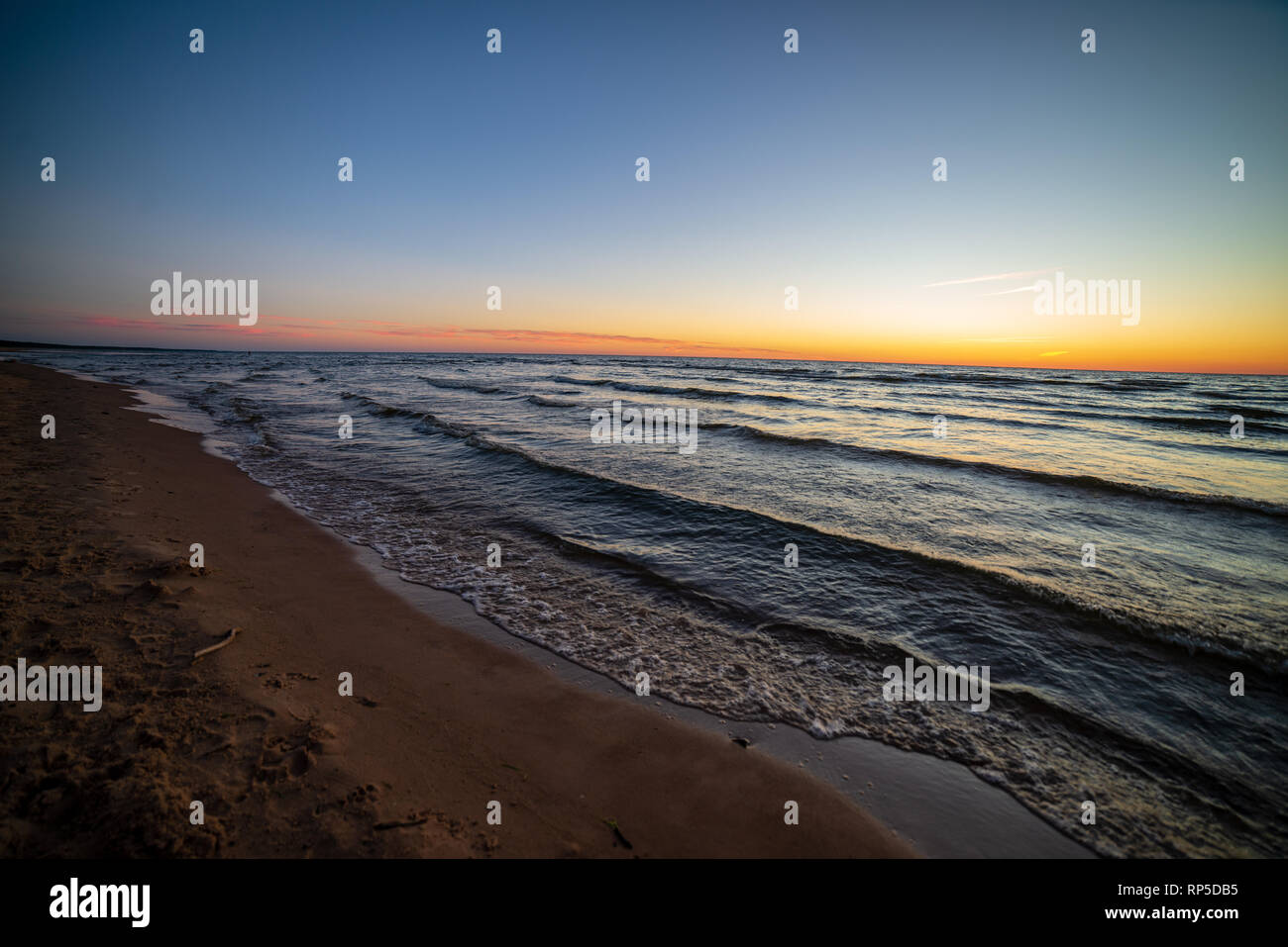 colorful sunset on the sea beach in summer with clean sky and calm ...
