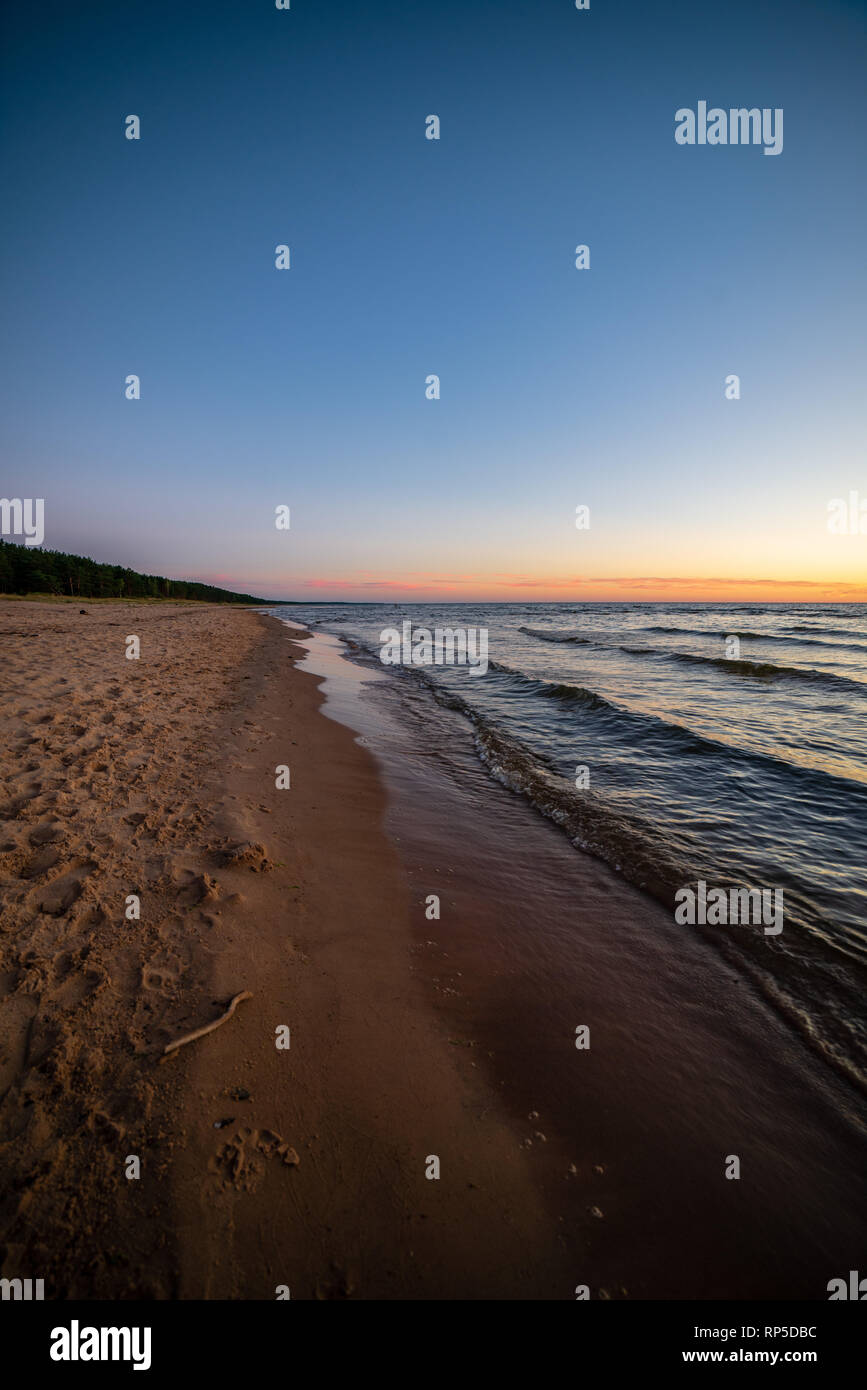 colorful sunset on the sea beach in summer with clean sky and calm ...