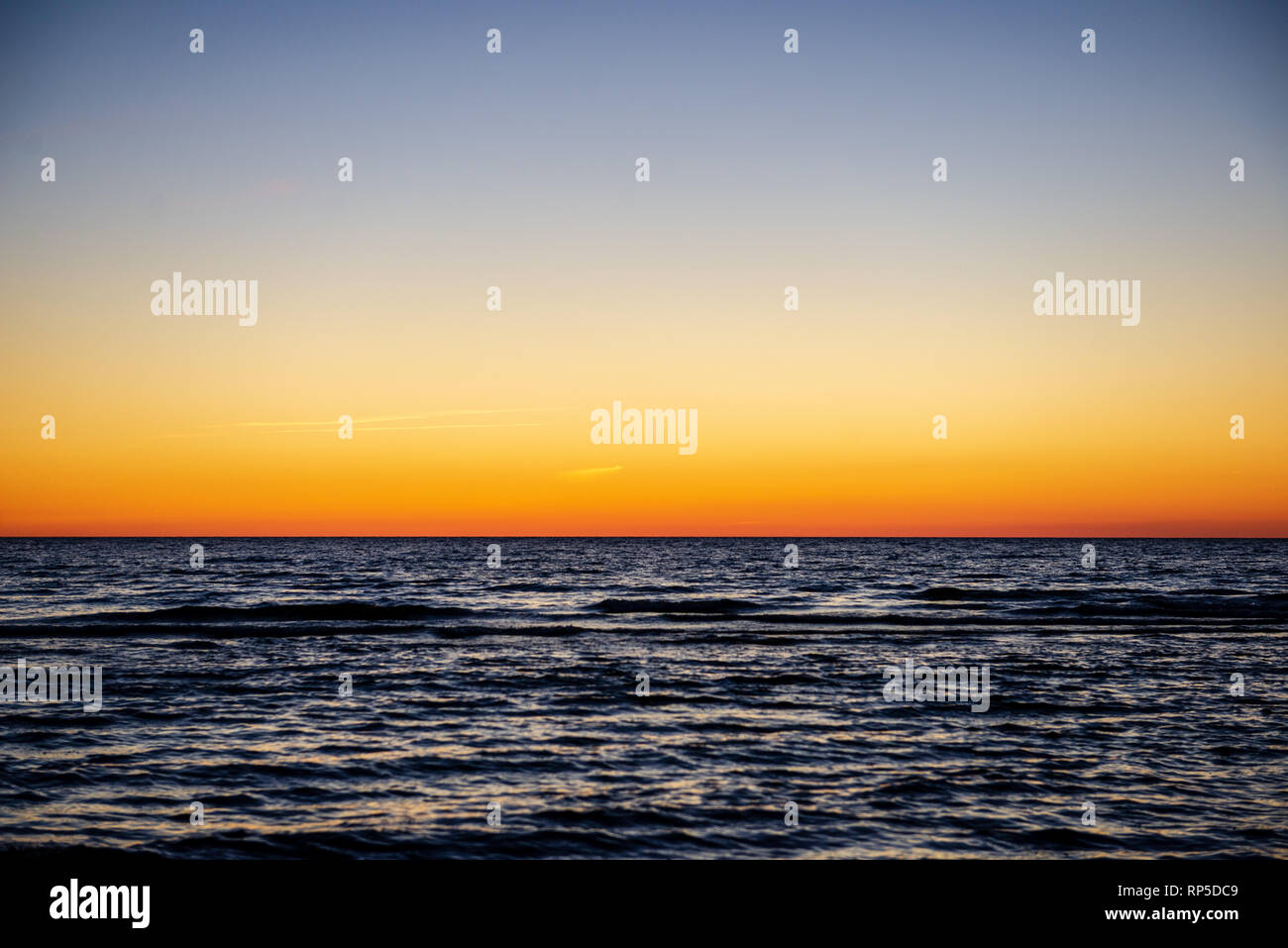 colorful sunset on the sea beach in summer with clean sky and calm ...