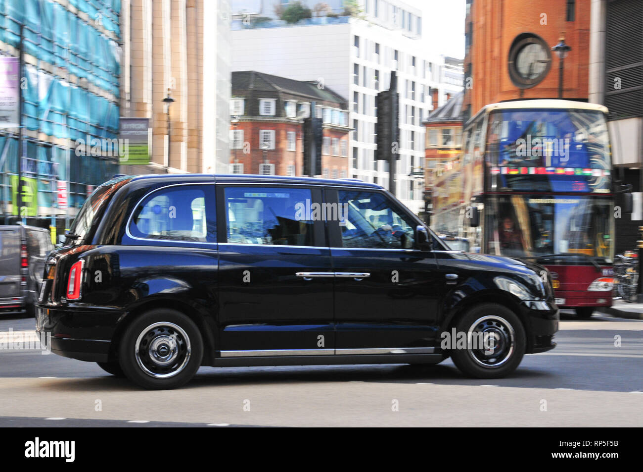 New LEVC TX taxi, black cab, driving on the streets of London Stock ...